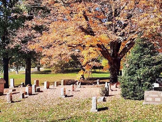 Autumn's golden embrace transforms this peaceful resting place into something almost magical, where history whispers through falling leaves.