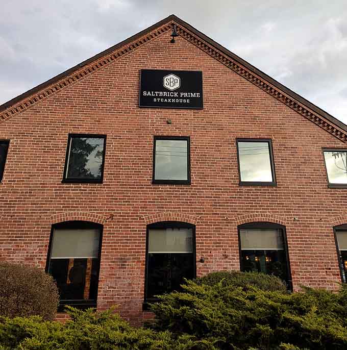 Historic brick architecture houses modern steakhouse excellence, proving old buildings make the best dining destinations every time.