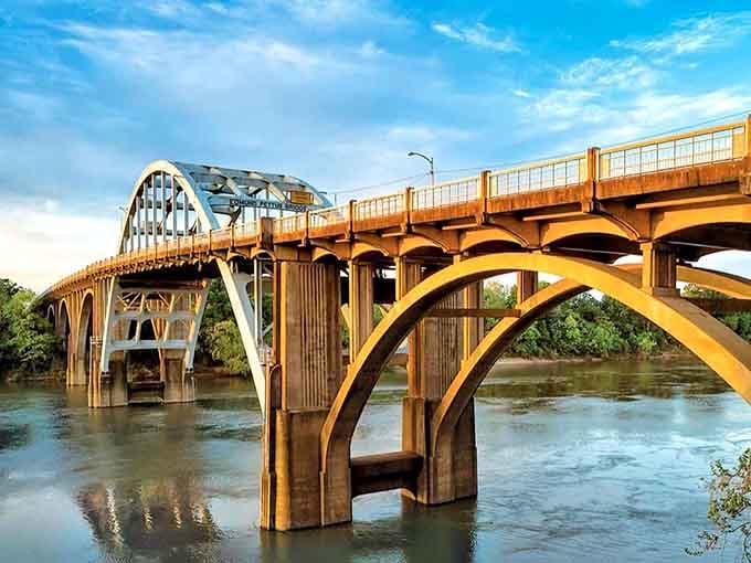 The Edmund Pettus Bridge stands proud, its Art Deco arches reflecting in waters that witnessed America's transformation.