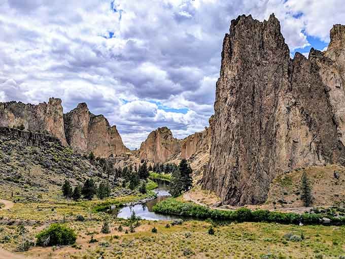 Towering rock spires in burnt orange hues rise dramatically above the winding river like a western movie set.