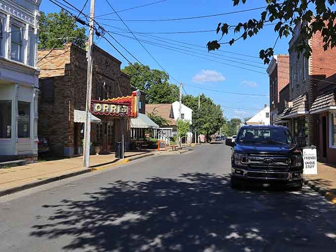 Sunlight dances on vintage storefronts where locals gather, creating community one conversation at a time still today.