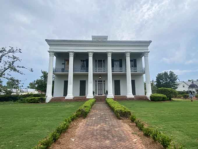 Towering white columns and manicured hedges showcase antebellum elegance that still commands respect and maybe reverence.