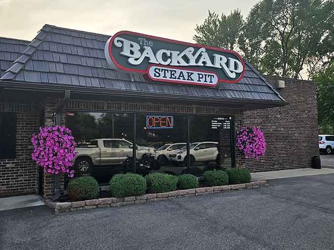 Purple petunias flanking the entrance prove that even serious steakhouses appreciate a little floral charm and curb appeal.