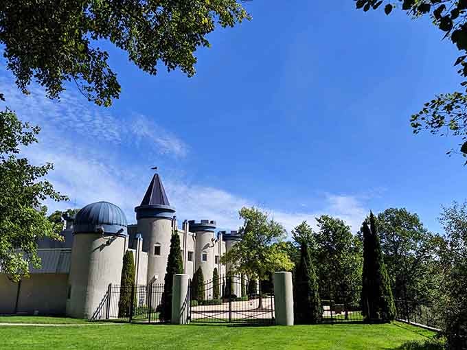 White towers and turrets rise behind iron gates, bringing medieval European grandeur to the Michigan countryside.