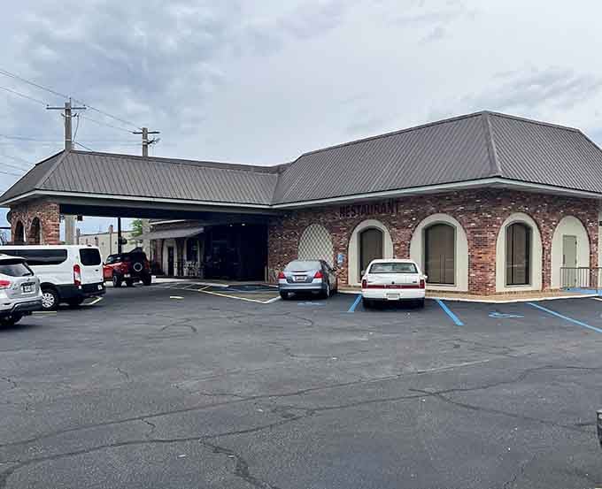 Classic brick architecture houses a dining room where generations have gathered for perfectly grilled steaks and warm memories.