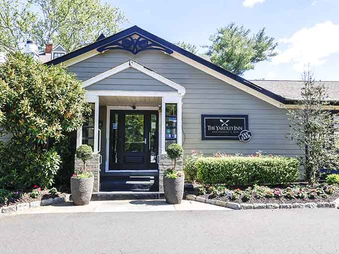 This charming cottage entrance with its manicured hedges whispers elegance while promising seafood that'll make you swoon inside.