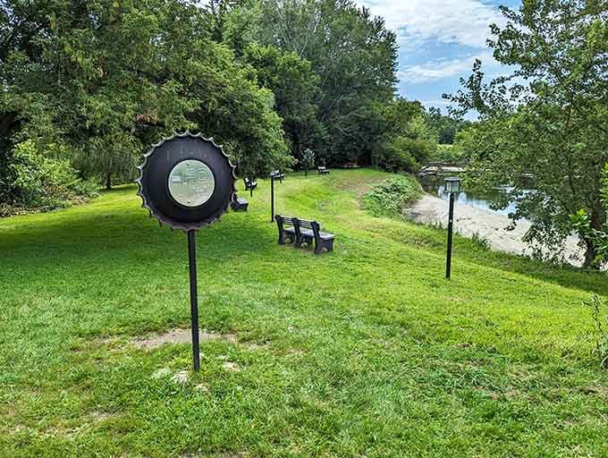 A giant bottle cap viewing scope overlooks the peaceful riverside where unexplained phenomena reportedly occurred decades ago.