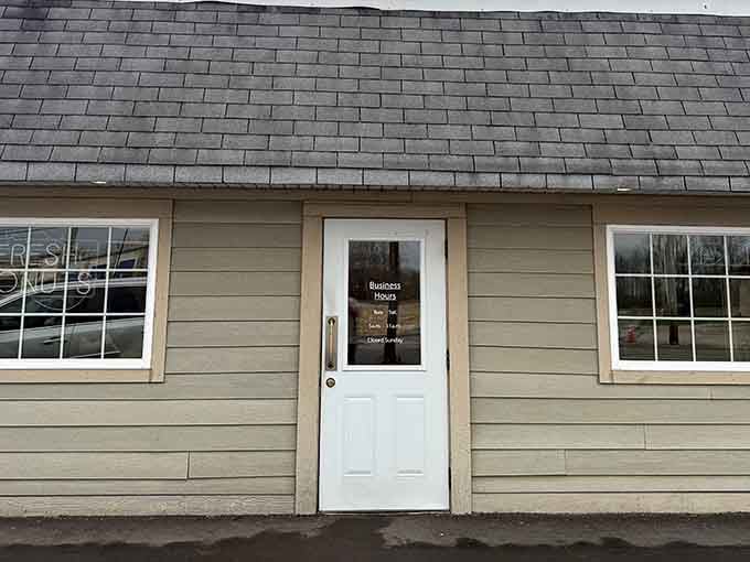 The simple door and cottage-style siding create an inviting entrance, like visiting a friend's kitchen where magic happens daily.