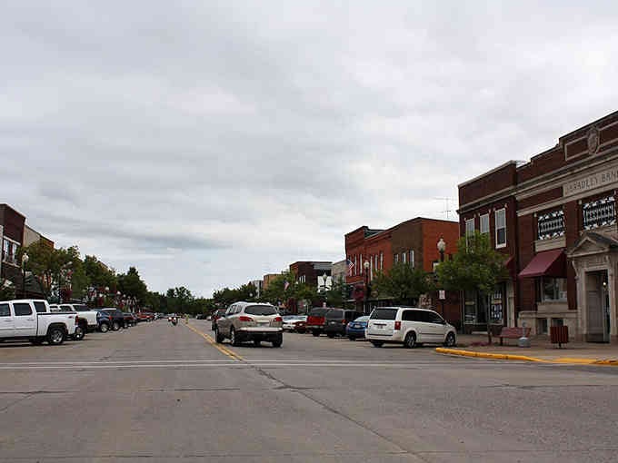 Brick buildings march down Main Street under dramatic clouds, creating a scene Norman Rockwell would've loved painting.