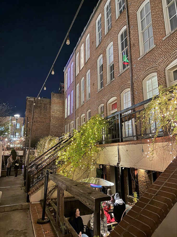 Historic brick buildings glow at night, transforming downtown Raleigh into a magical urban dining destination.