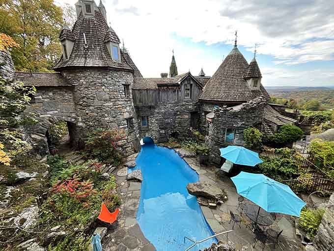 Handcrafted stone turrets and whimsical towers rise from the hillside like a storybook illustration come to life.