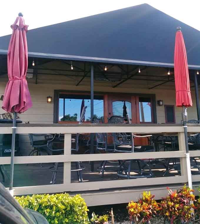 Pink umbrellas and waterfront dining create a breezy beach vibe perfect for enjoying premium cuts by the Gulf.