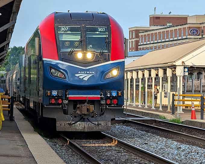This sleek red and blue locomotive pulls into the station with headlights blazing, looking surprisingly futuristic for good old-fashioned rail travel.