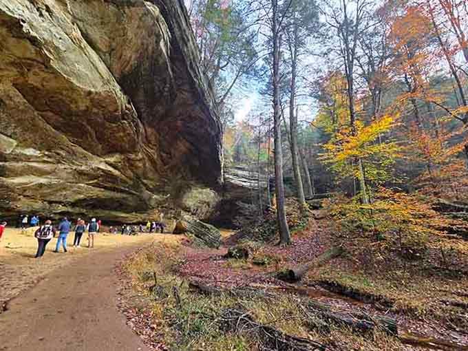 The massive horseshoe-shaped overhang shelters visitors like a stone umbrella built by ancient forces.