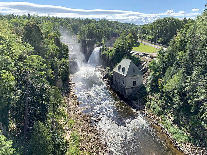 The historic building perches beside rushing water, creating a postcard-perfect scene that belongs in a coffee table book.