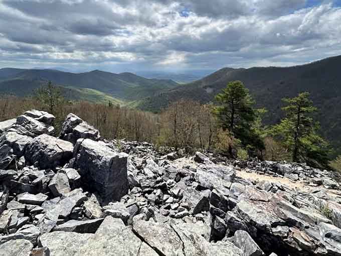 Dramatic skies hover above the rocky peak, reminding us that the best views require a little effort and sturdy shoes.