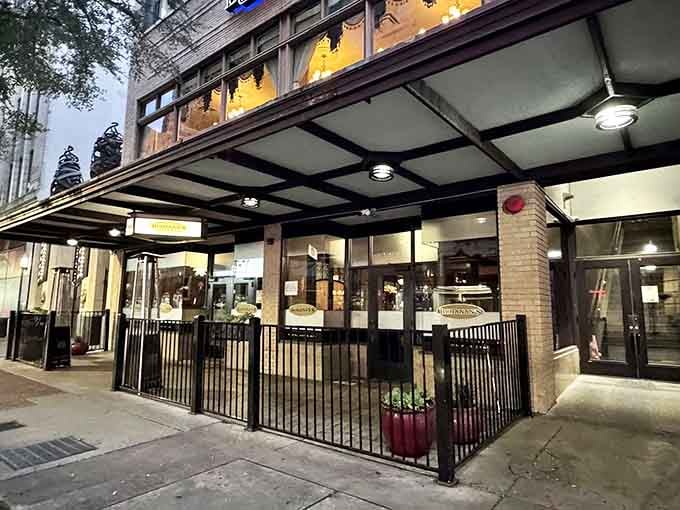 The covered entrance glows invitingly at dusk, promising the kind of meal you'll be talking about for weeks.