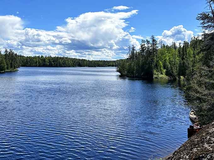 Puffy clouds drift over endless blue water dotted with forested islands begging exploration.