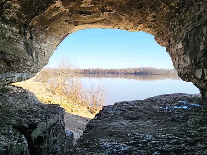 Framed perfectly by stone walls, the Ohio River sparkles beyond the cave's natural window like a postcard from frontier days.