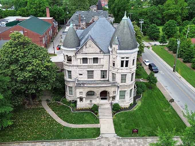 From above, this architectural masterpiece resembles a stone crown jewel nestled in emerald Kentucky countryside.