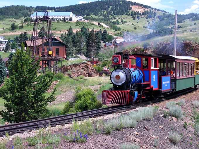 Historic mining town backdrop with a train that looks like it raided a paint store's brightest aisle&mdash;delightfully quirky!