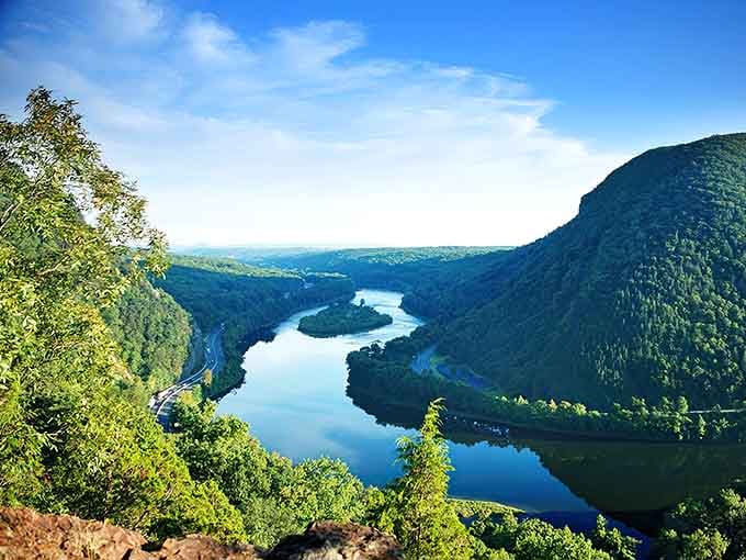 Morning light catches the Delaware's curve between green mountains, creating a view that stops conversations mid-sentence every time.