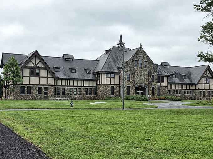 Manicured grounds stretch before this stunning estate where nature and architecture dance together in perfect harmony.