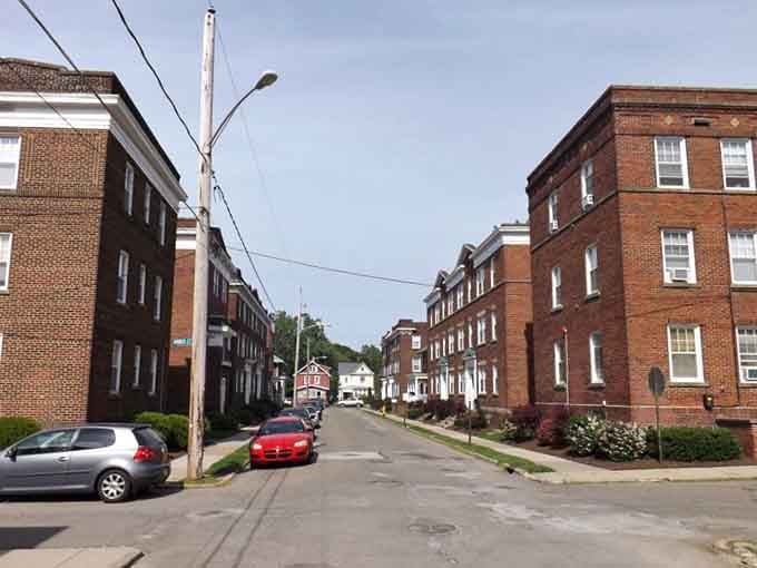 Mountains frame this downtown corridor where vintage buildings stand proud against a sky that promises new possibilities ahead.