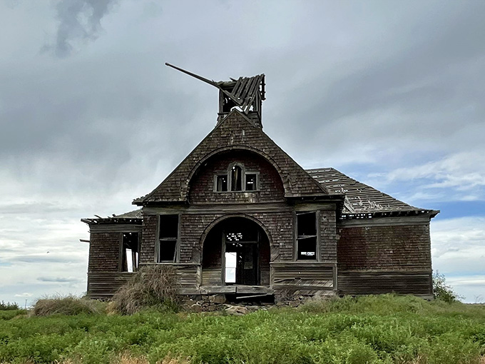 Closer inspection reveals every weathered board and broken window, each telling stories of Sunday services and community gatherings long past.