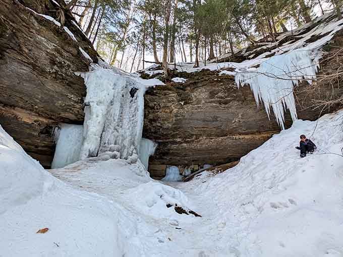 Massive icicles frame the sandstone amphitheater like organ pipes in a frozen concert hall waiting for its first performance.
