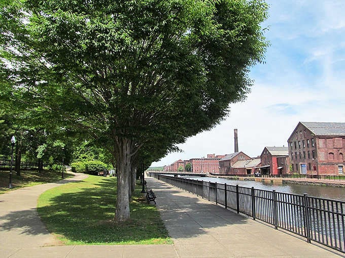 Shaded riverside paths wind past historic mill buildings, offering peaceful walks where industry once thundered.