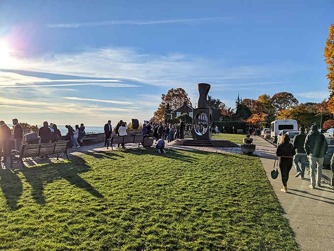Golden hour transforms the city into a glowing masterpiece while visitors gather to witness Seattle's evening magic.