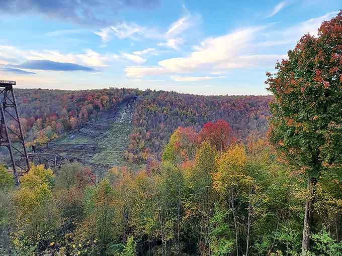Autumn paints the gorge in brilliant reds and golds while the bridge remains stand as silent witnesses to history.