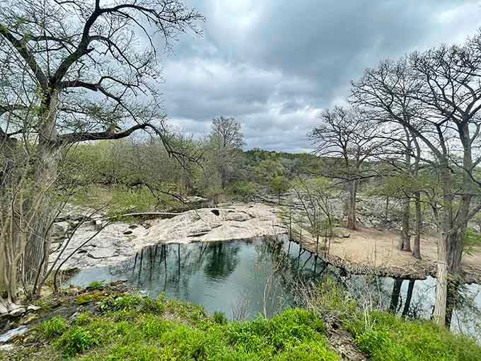 Storm clouds gather overhead, but the spring-fed pool below remains perfectly calm and inviting as ever.
