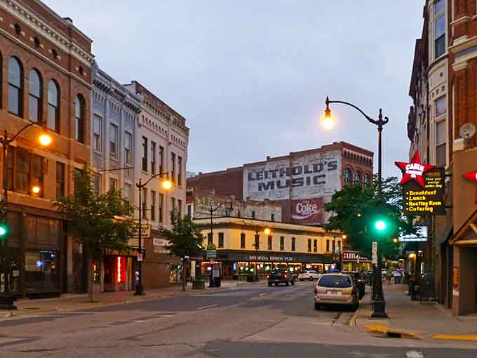 Those vintage signs and streetlights create magic hour perfection, turning an evening stroll into pure Main Street nostalgia.