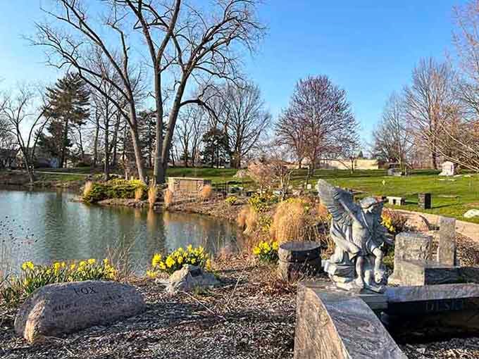 Winter's bare branches frame the peaceful landscape where history rests beneath thoughtfully designed monuments and sculptures.