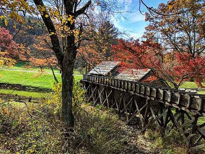 Fall colors explode around the historic mill, where the wooden sluice carries water just like it did generations ago.