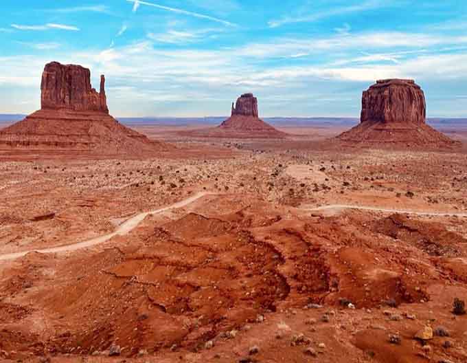 The famous Mittens and Merrick Butte stand tall against the horizon, creating the iconic view you've seen in countless Western movies.