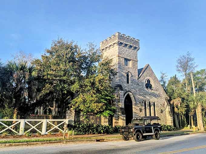That vintage vehicle parked outside adds character to this castle's already impressive stone facade and battlemented tower.