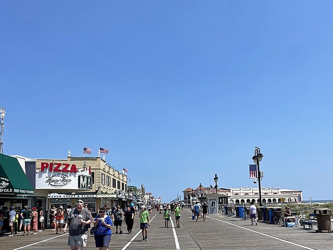 Classic boardwalk architecture meets blue skies in Ocean City, where pizza signs promise delicious fuel for your seaside adventures.