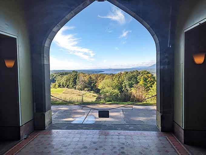 Through the Moorish archway, rolling hills stretch toward distant mountains in a view that's absolutely worth framing.