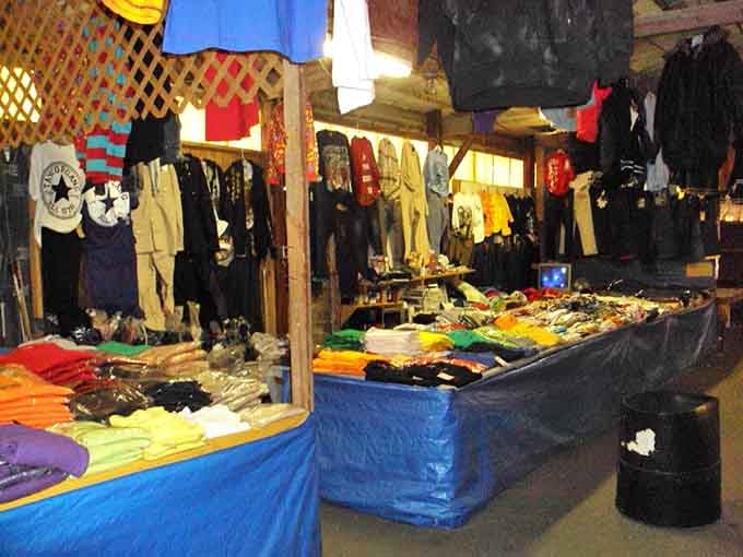 Rainbow mountains of t-shirts overflow blue bins, offering more color choices than a Crayola factory tour.