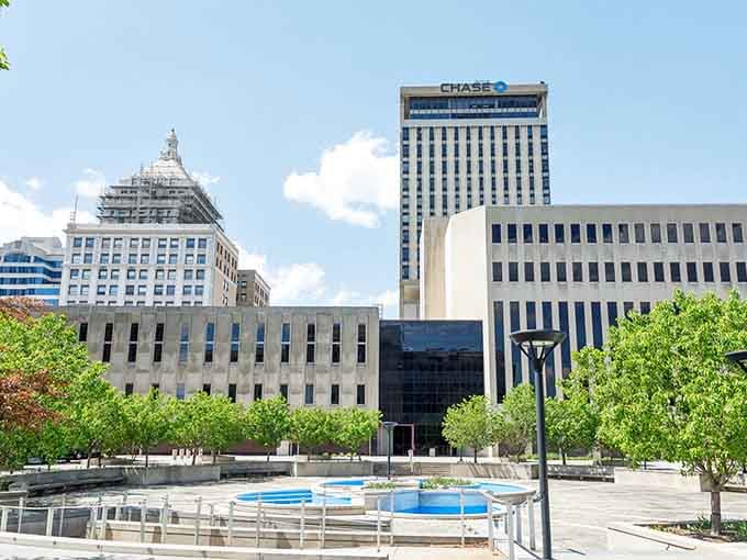 Modern plaza fountains dance beneath historic buildings, blending old and new in perfect affordable harmony together.