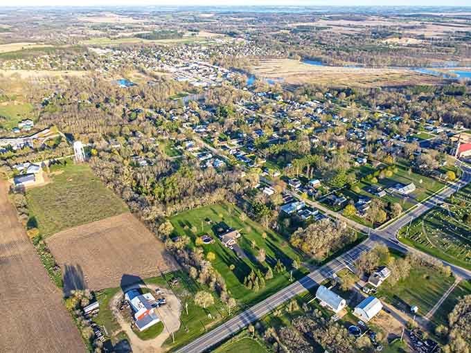Aerial view reveals a town embraced by farmland and trees, where community roots run deep and life feels genuinely peaceful.
