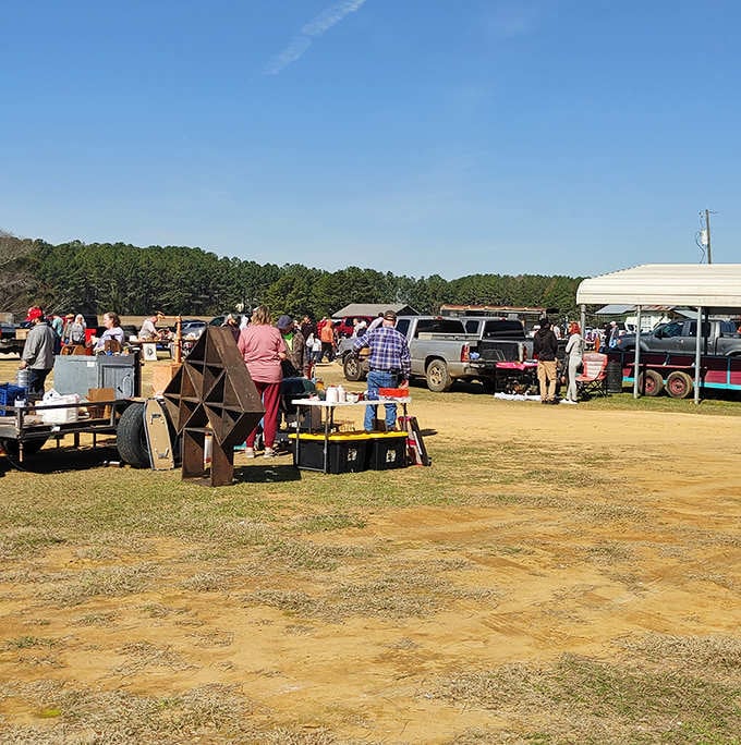 That rustic wooden display piece catches the eye while shoppers in colorful clothes browse tables loaded with hidden gems.