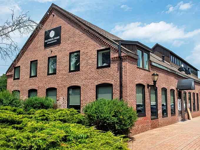 Lush green landscaping frames this handsome brick building where prime cuts meet New England charm beautifully.