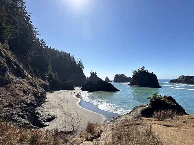 This secluded cove between towering rocks feels like discovering your own private slice of coastal paradise.