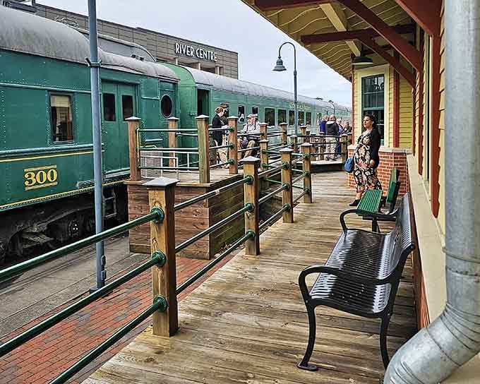 River Centre station bustles with anticipation as passengers gather along the wooden platform for their scenic adventure.