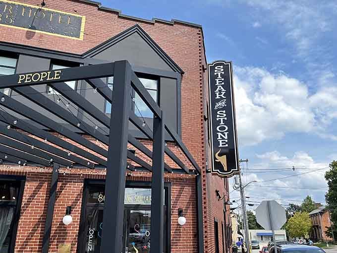 The covered patio and vertical signage promise interactive dining experiences in the heart of the public square.