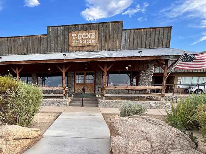 The weathered wood and desert landscaping frame a steakhouse experience that's as authentic as Arizona gets.